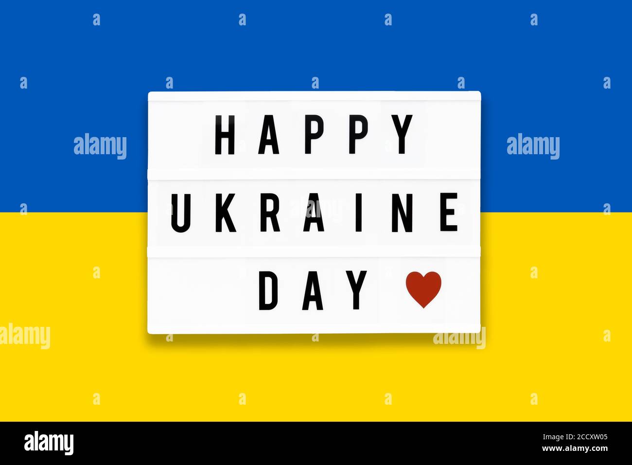 HAPPY UKRAINE DAY written in a lightbox on a background of Ukraine flag ...