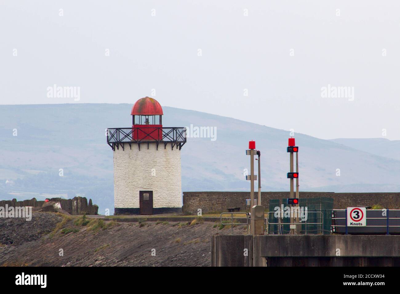 Lighthouse and signals at harbour entrance Stock Photo - Alamy
