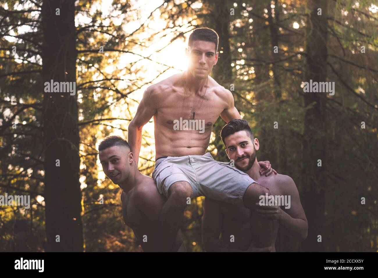 Three guys doing exercise in the forest Stock Photo - Alamy