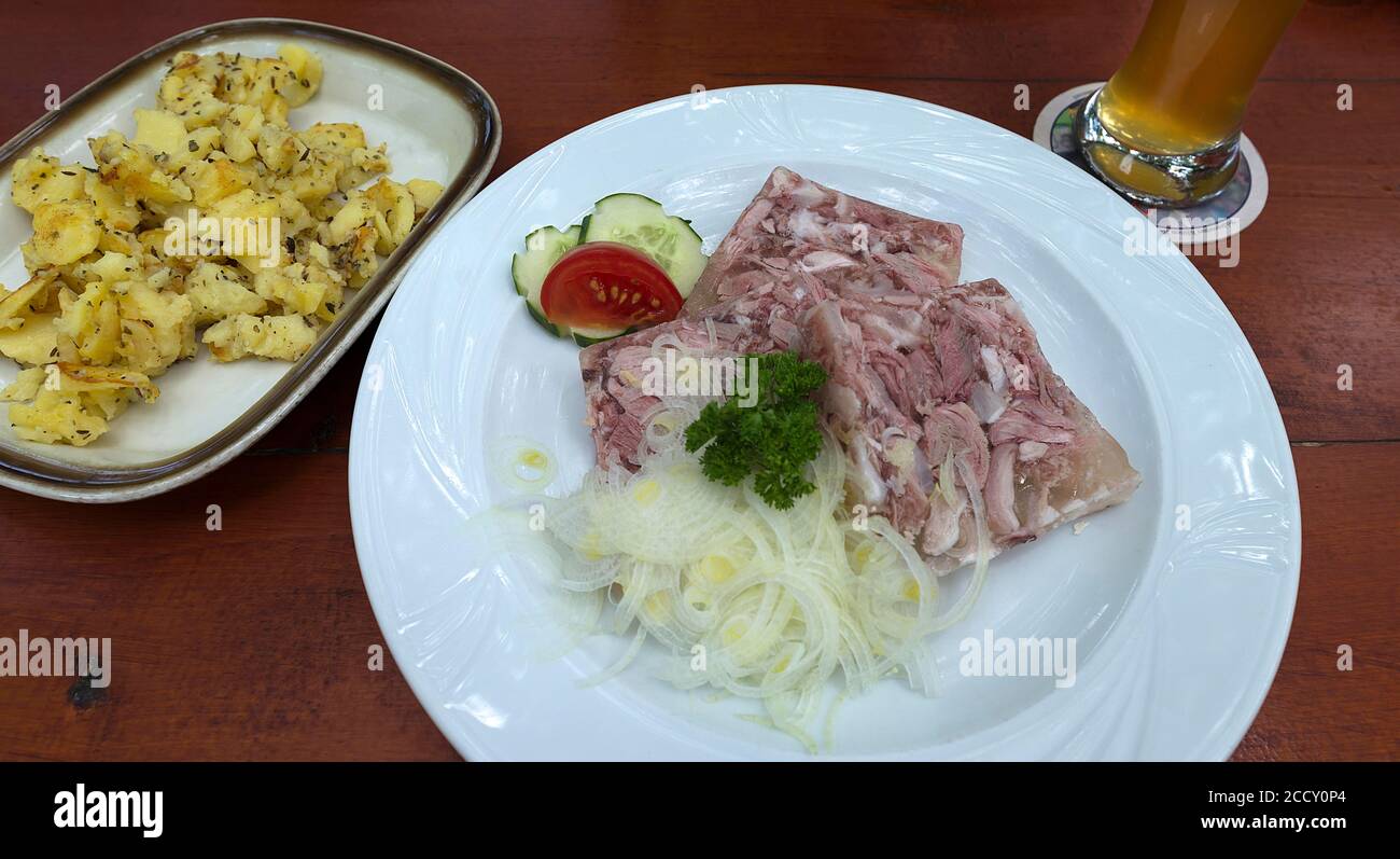 Brawn with fried potatoes and wheat beer on a beer table, Franconia ...