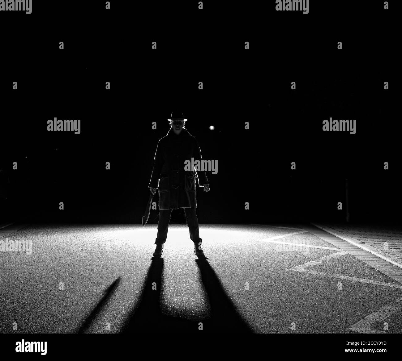 Woman with big knife in backlight with black shadow, mysterious ...