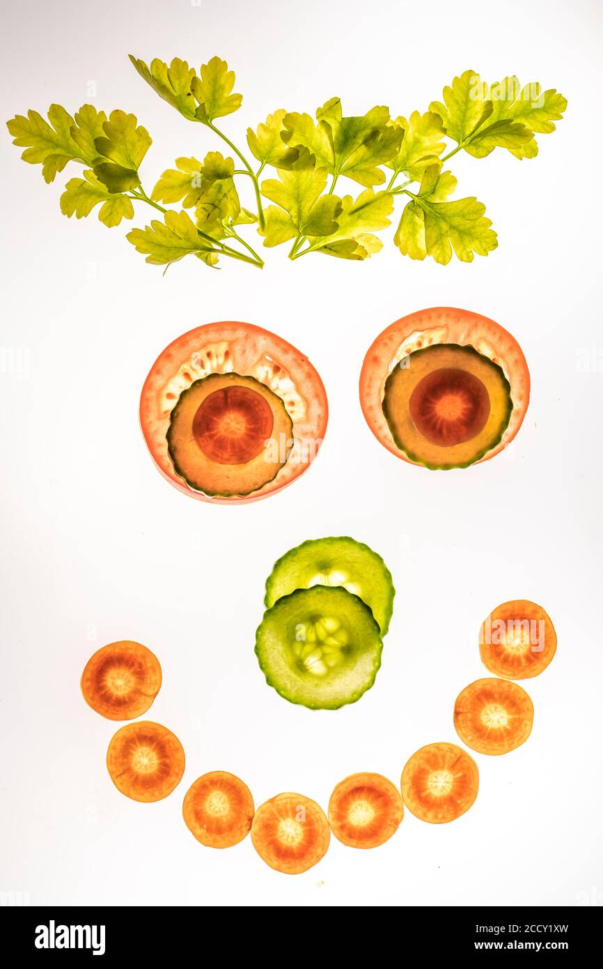 Laughing face of vegetables, smiley face, slices of cucumber, carrot ...