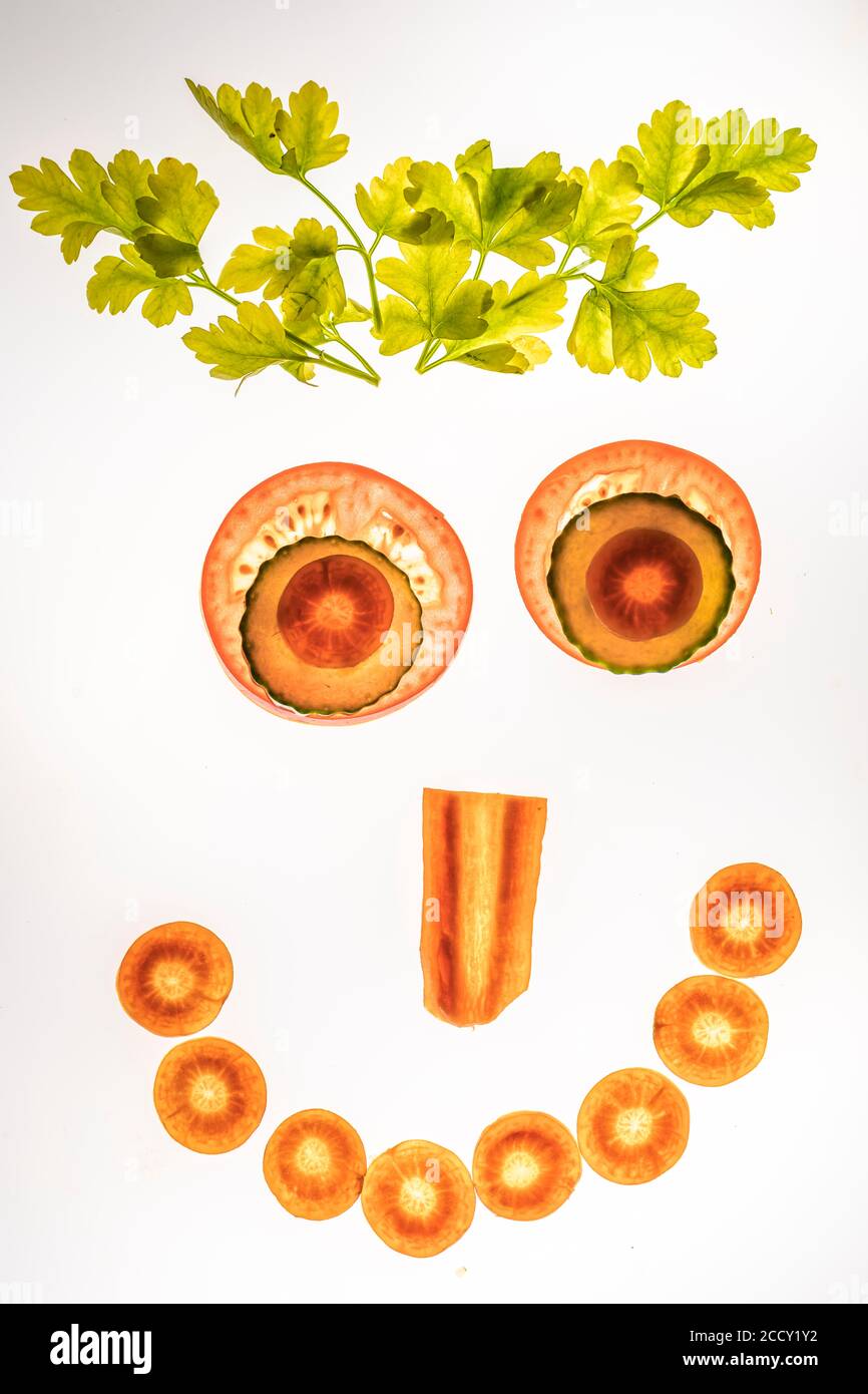 Laughing face of vegetables, smiley face, slices of cucumber, carrot ...