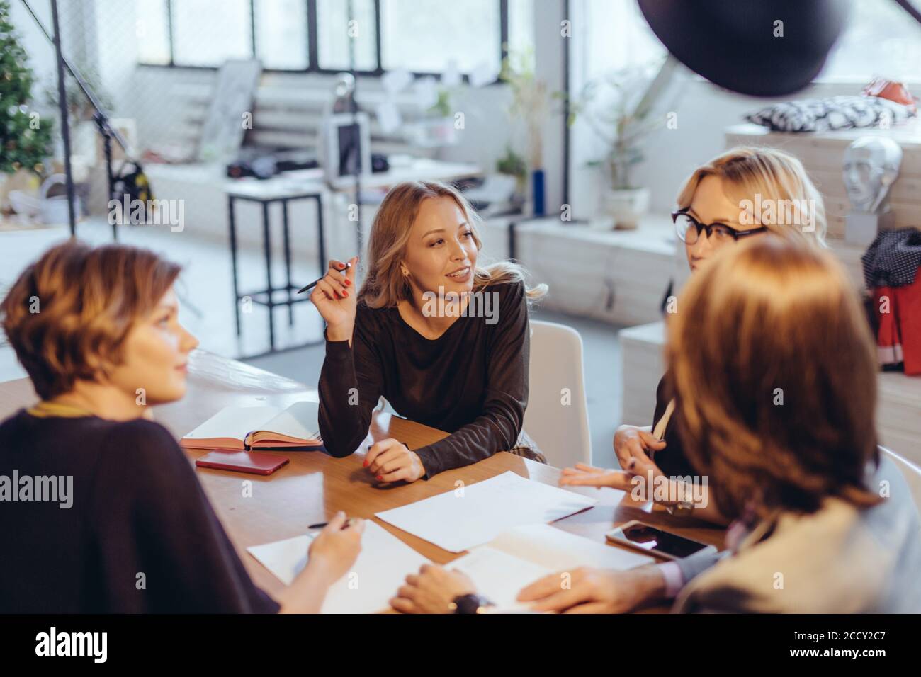 Working overtime concept. Group of young business team working late at ... Working overtime concept. Group of young business team working late at ...