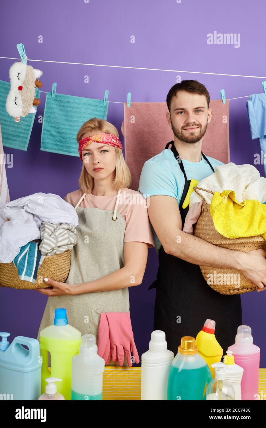family spending time doing washing. young couple washing clothes by ...