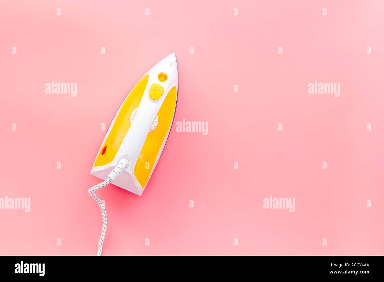 Top view of yellow iron on ironin board Stock Photo - Alamy
