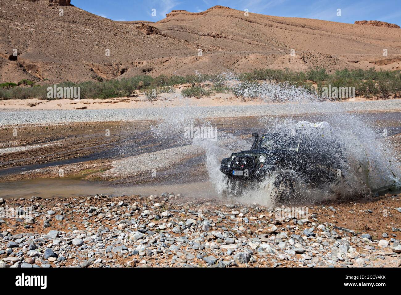 Off-road vehicle crosses a river in the Middle Atlas, Morocco Stock ...