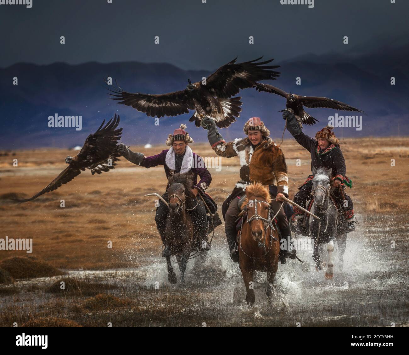 Three kazakhs on horseback with trained eagles hi-res stock photography and images - Alamy