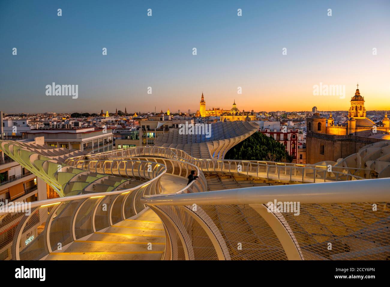 View over Sevilla from Metropol Parasol at sunset, curved wooden ...