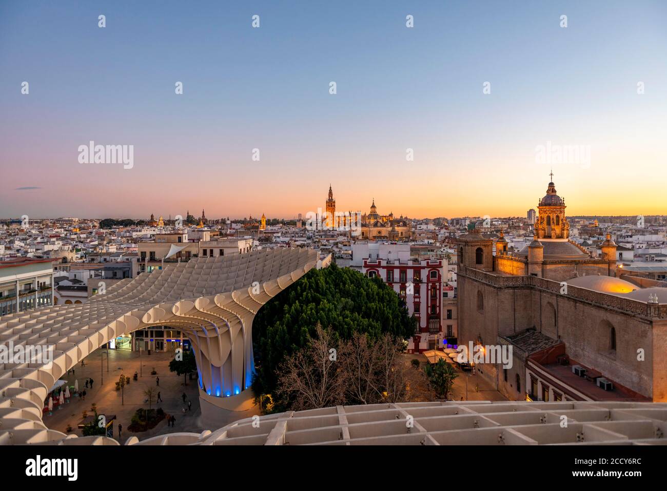 View over Sevilla from Metropol Parasol at sunset, curved wooden ...