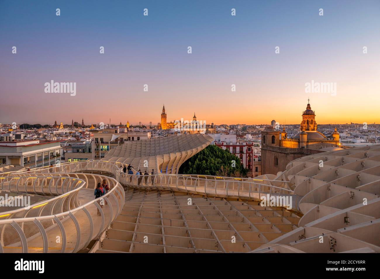 View over Sevilla from Metropol Parasol at sunset, curved wooden ...