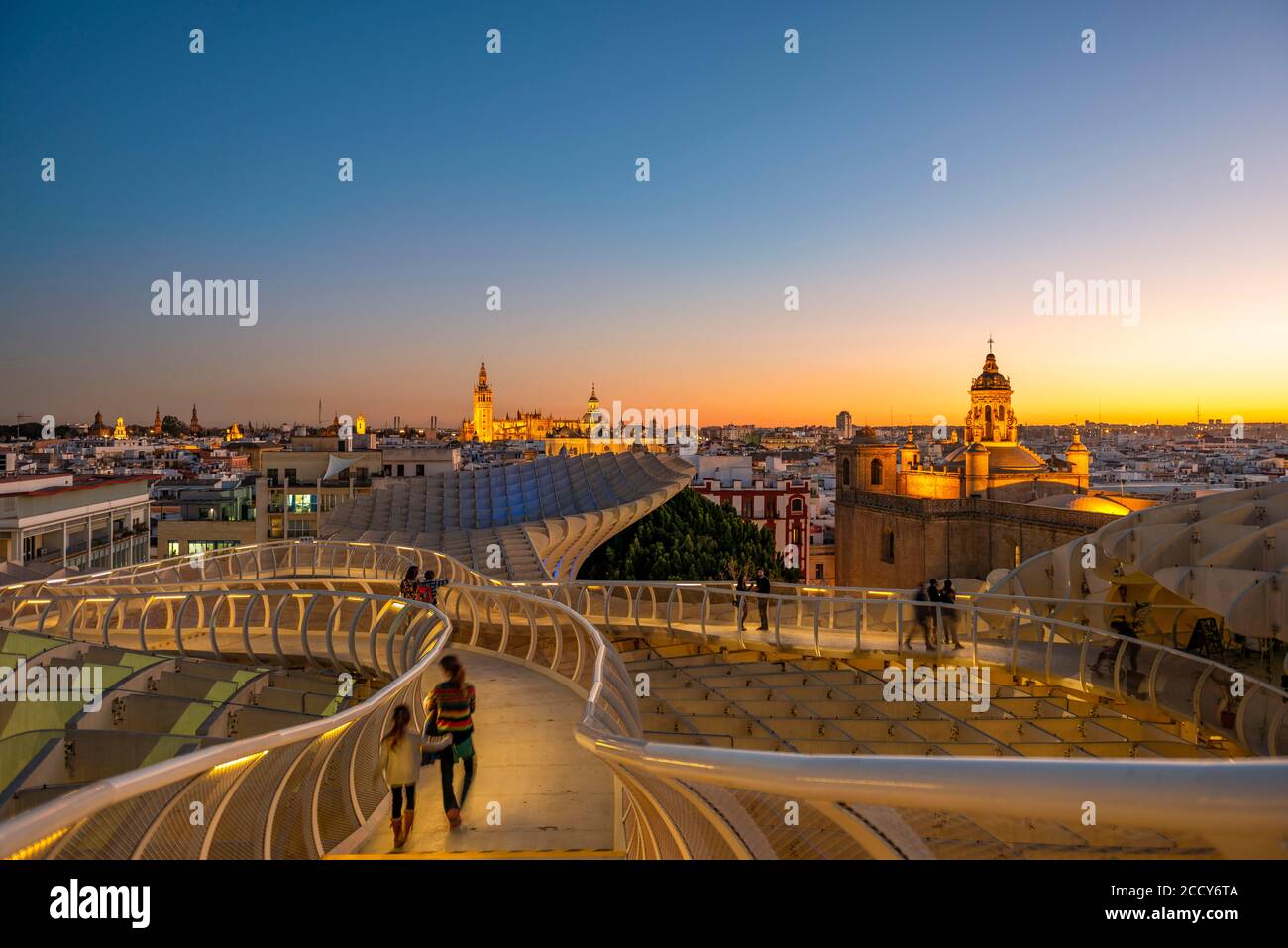 View over Sevilla from Metropol Parasol at sunset, curved wooden ...