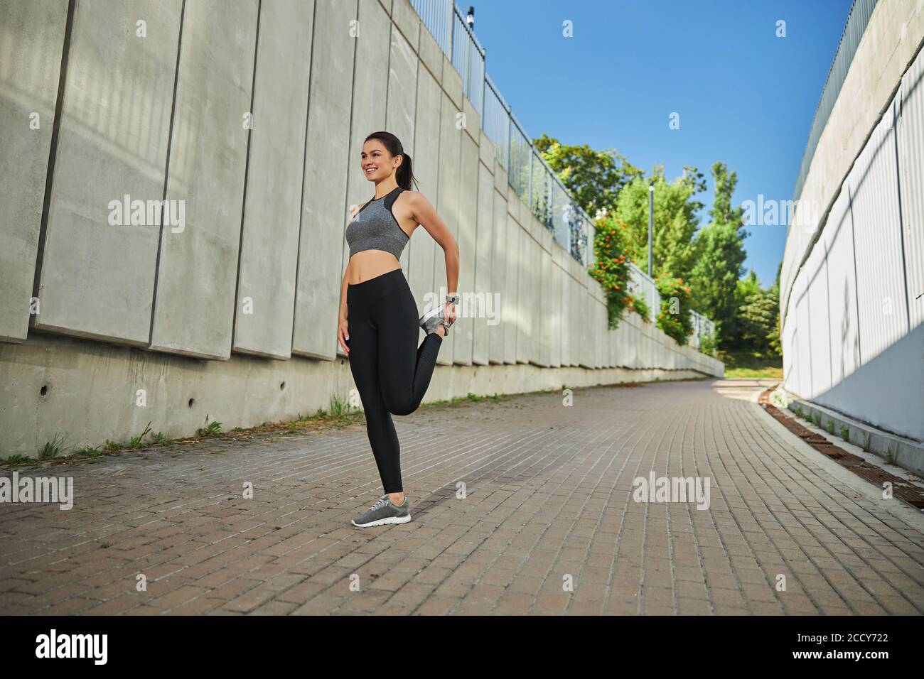 Positive delighted female person stretching her body Stock Photo - Alamy