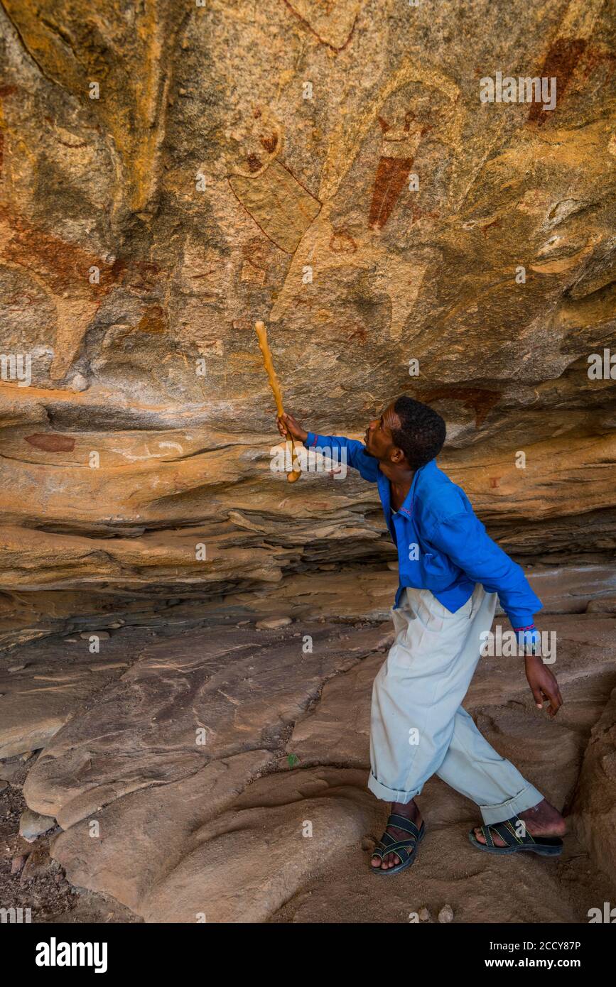 Guide pointing at cave paintings in Laas Geel caves, Somaliland ...