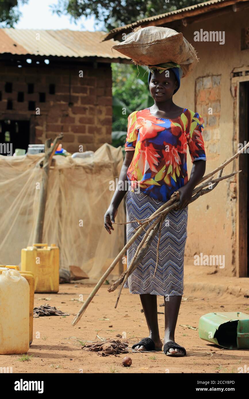 Woman carrying load on head, Uganda, East Africa Stock Photo - Alamy