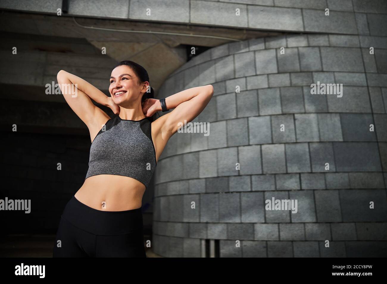 Positive delighted brunette woman stretching her body Stock Photo - Alamy