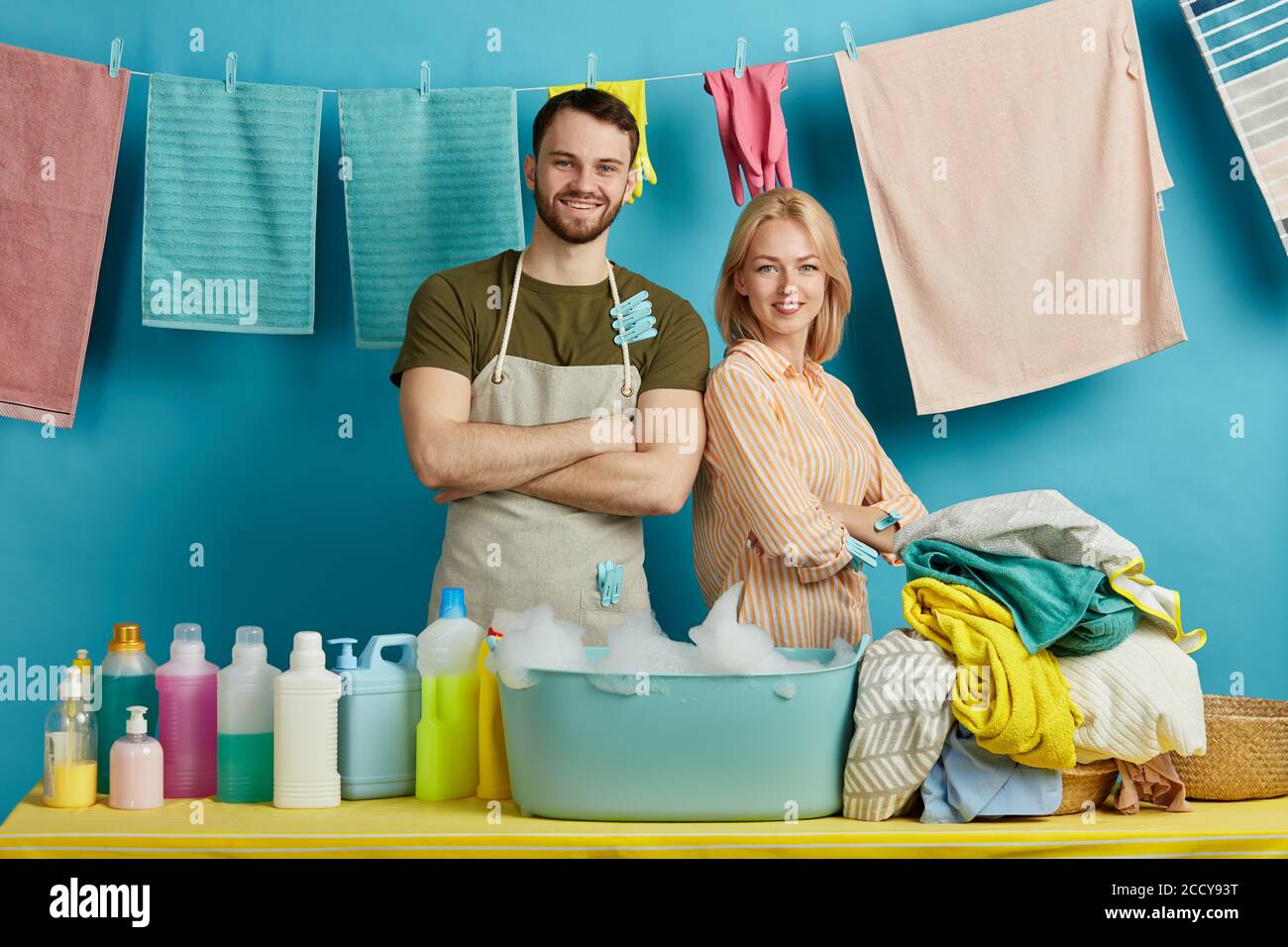 happy young couple are ready to wash clothes at workplace. close up ...