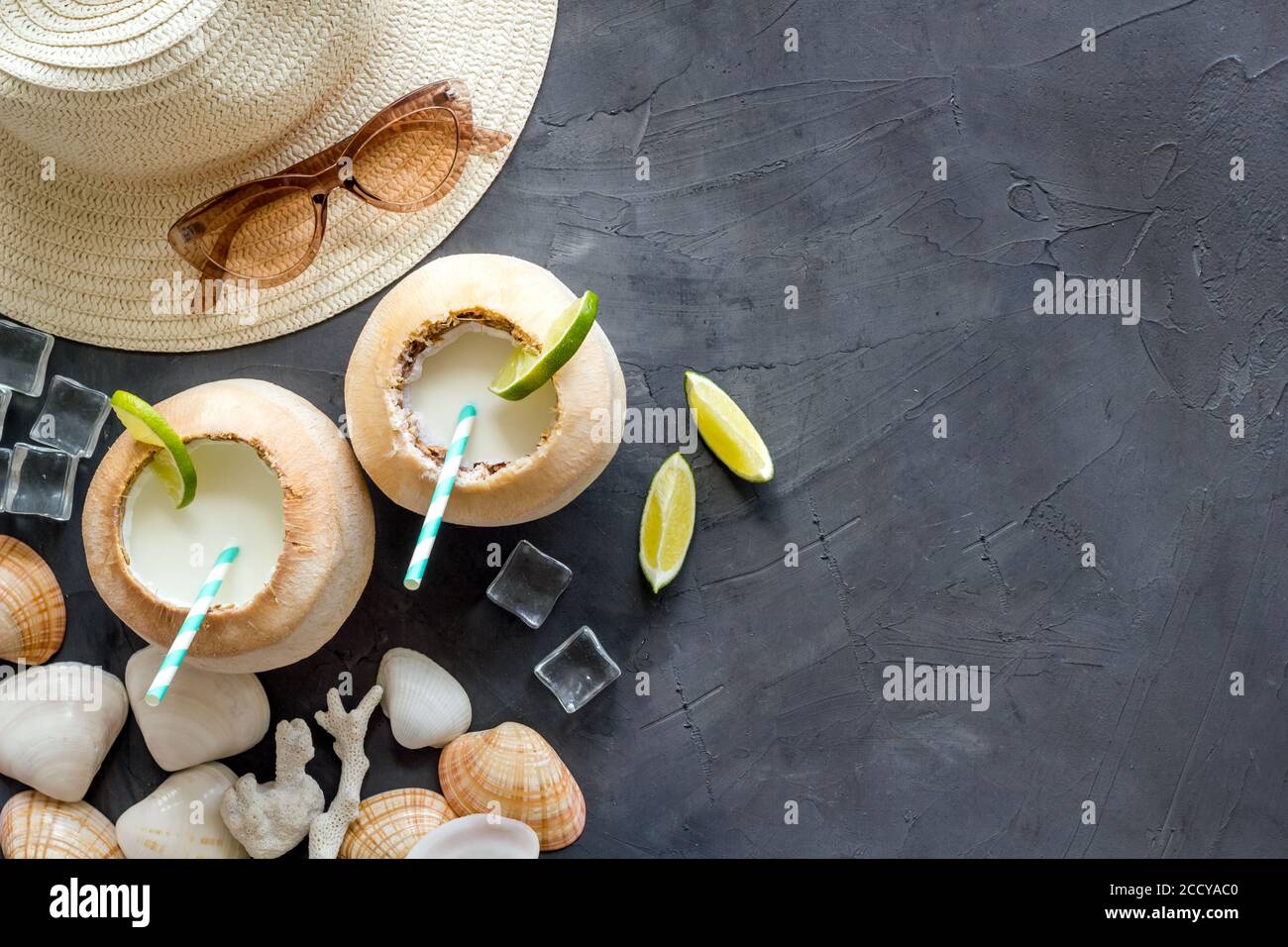 Young coconut water with straw on beach background, top view Stock ...