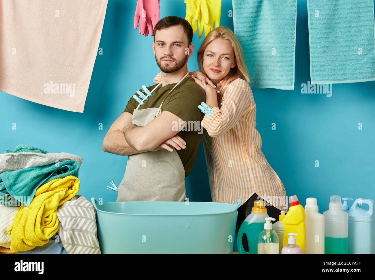 attractive woman and her assistant spending time in the laundry room ...