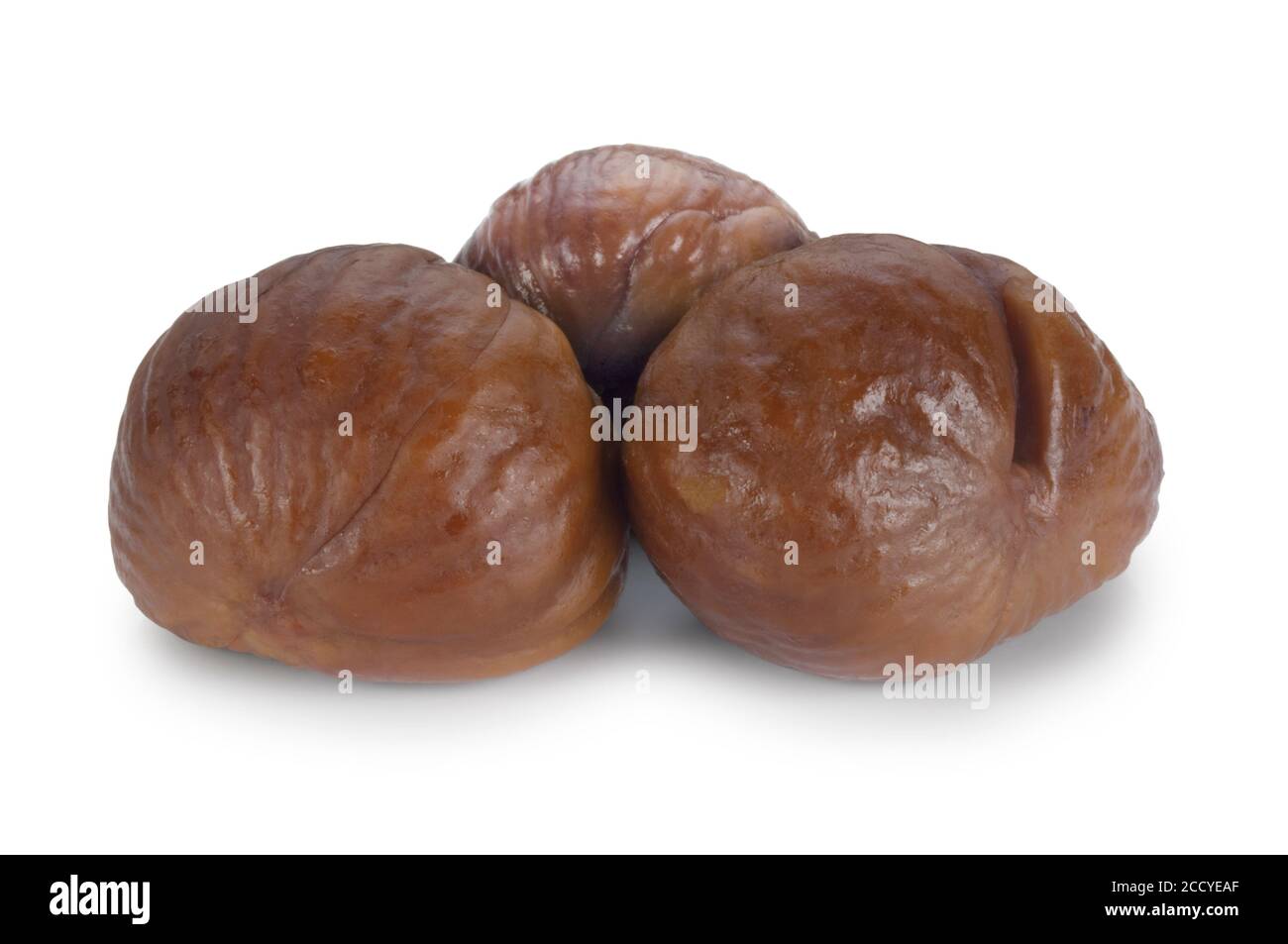 Studio shot of cooked, peeled, sweet chestnuts cut out against a white ...