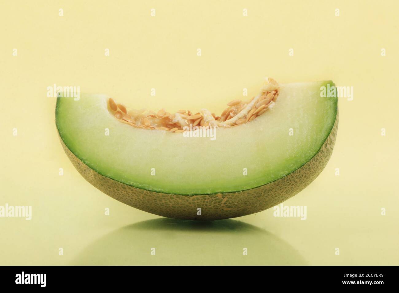 One slice of melon on the surface of the yellow base Stock Photo - Alamy