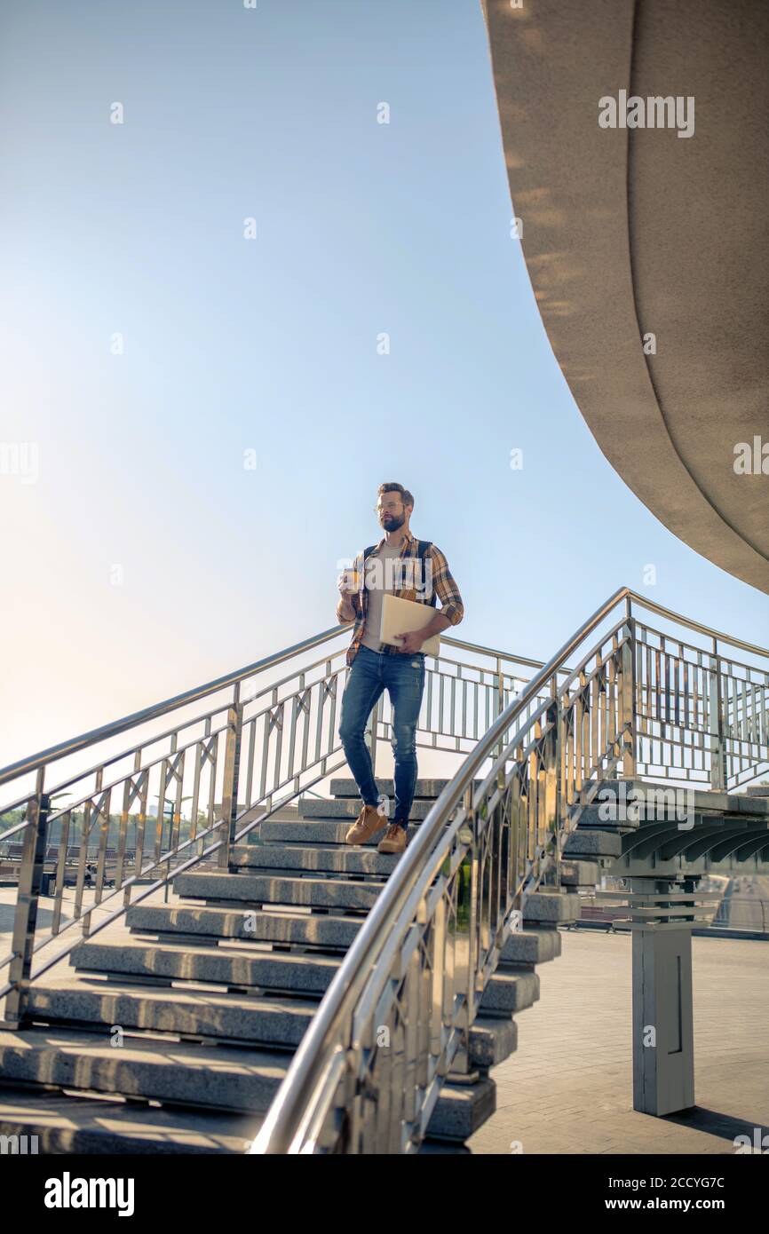 Man going downstairs hi-res stock photography and images - Alamy
