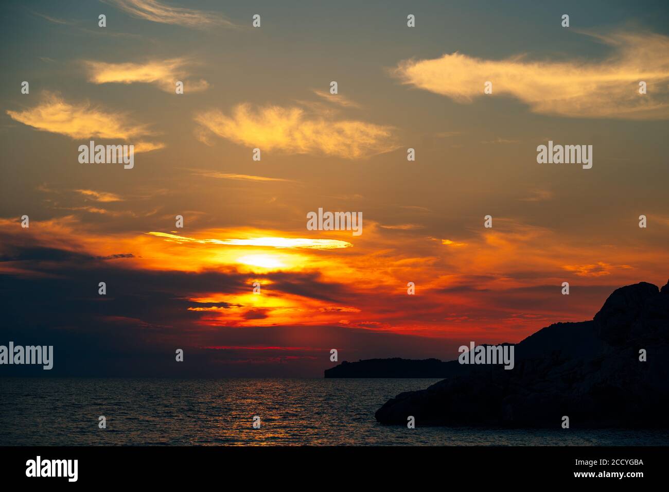 Fiery red sunset sky over the sea Stock Photo - Alamy