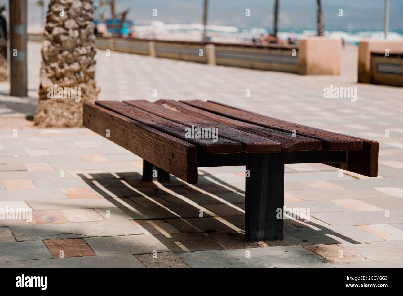 Empty bench in front of the beach on the boardwalk Stock Photo - Alamy