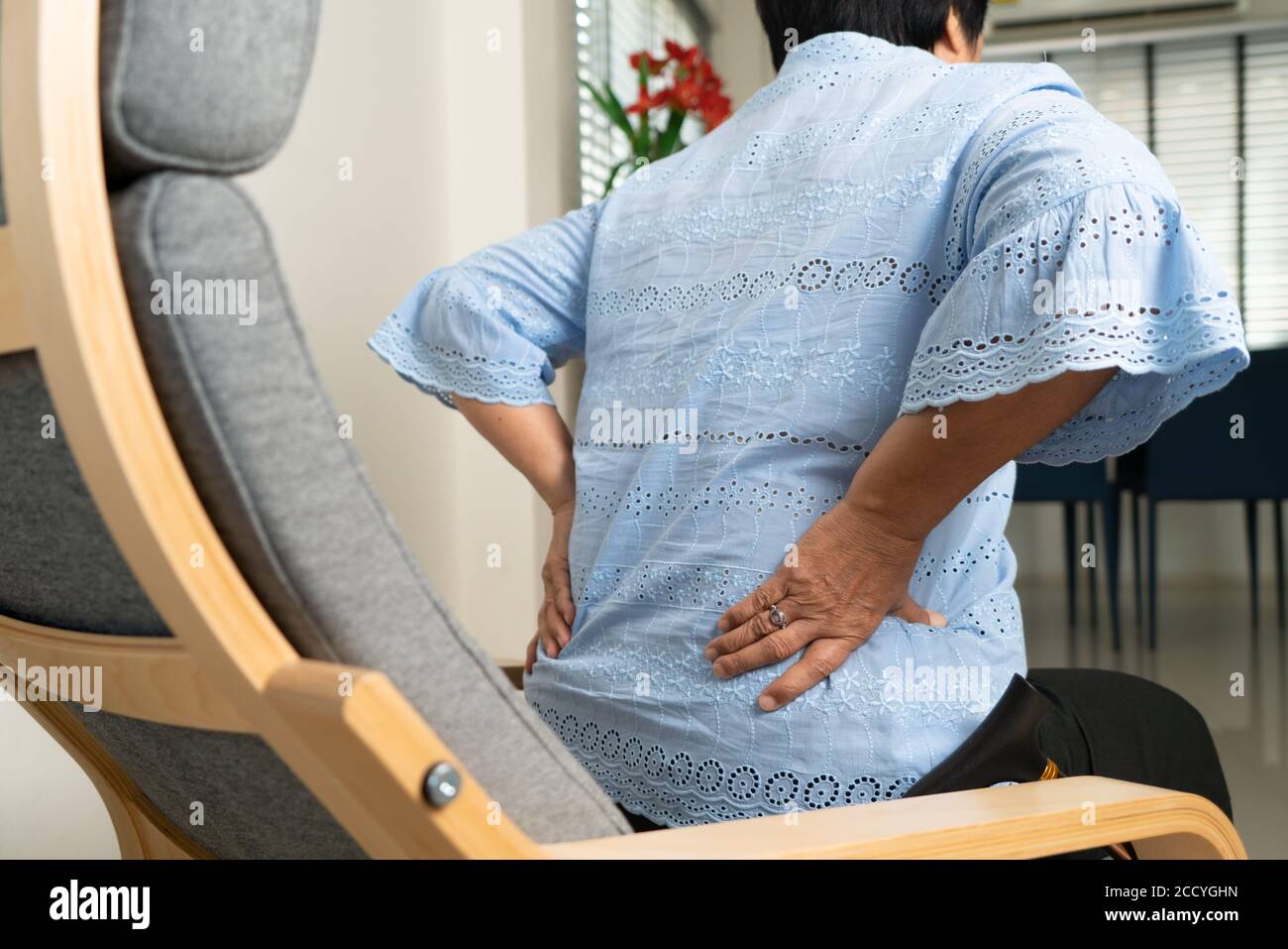Old woman back pain at home, health problem concept Stock Photo - Alamy