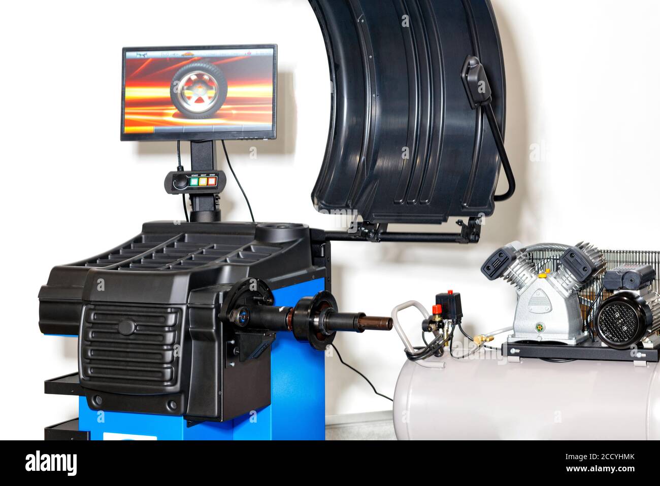 Car wheel balancer and air compressor, copy space, close-up Stock Photo ...