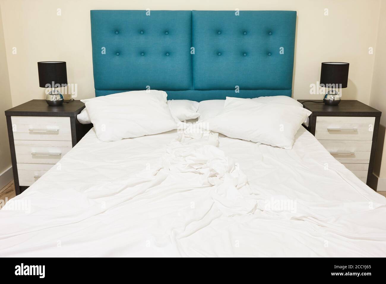 Bedroom with unmade double bed. Indoor nobody. Horizontal Stock Photo ...