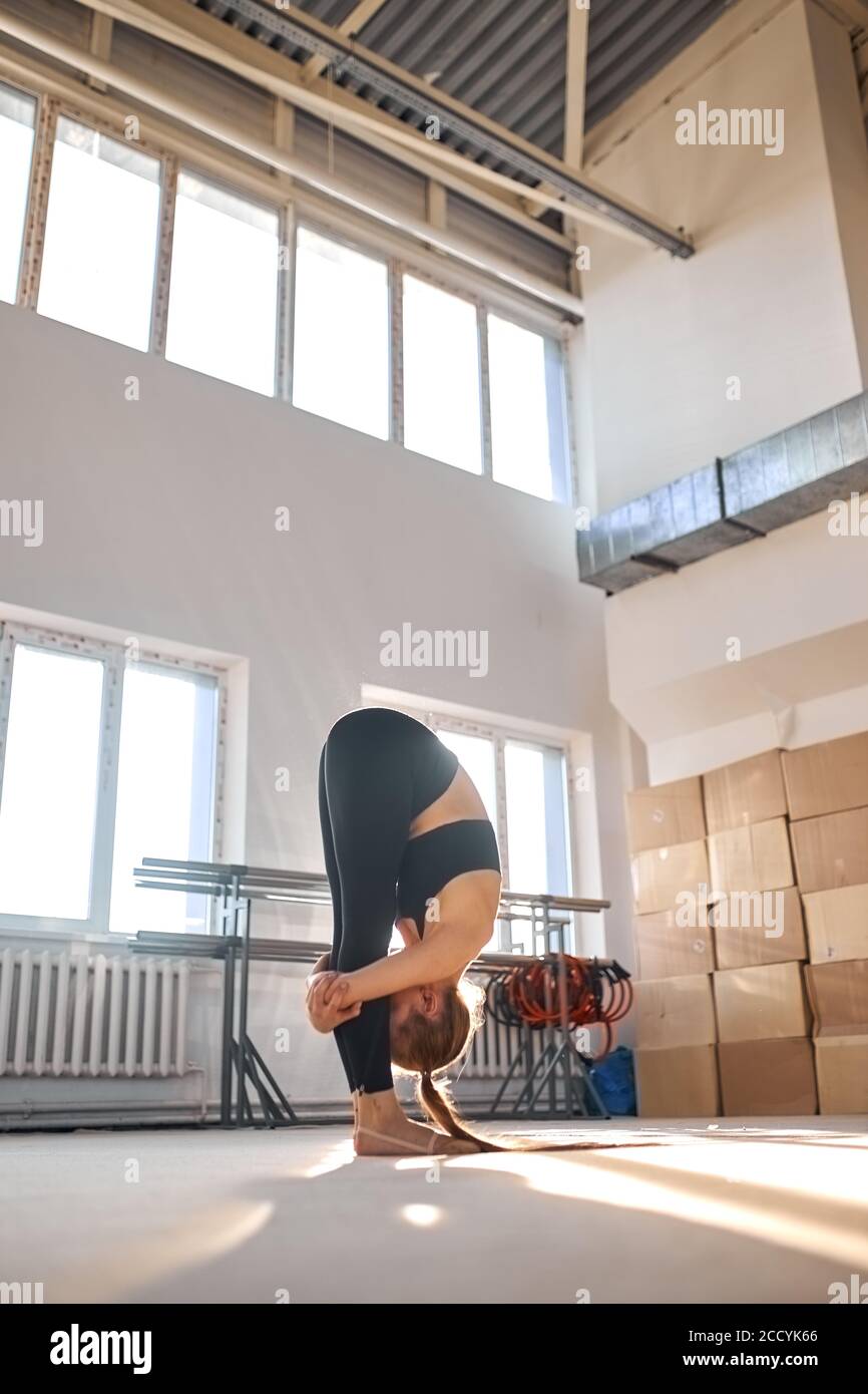 Sporty beautiful young woman doing gymnastics excersises , intense ...