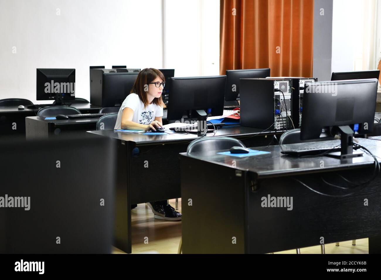 Only one female student in computers and technology classroom working ...