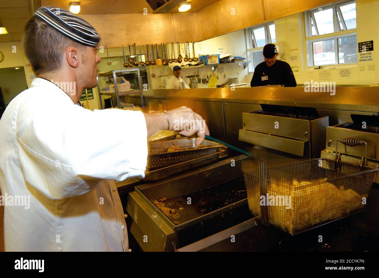 Chef prepares chips for hospital menu in NHS hospital kitchen West ...