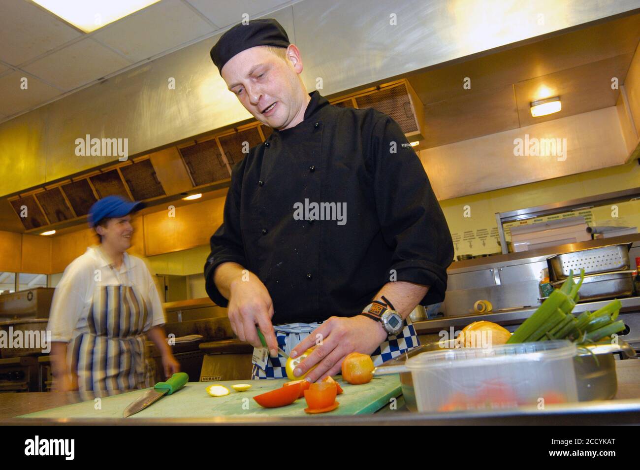 Chef prepares salad for hospital menu in NHS hospital kitchen West ...