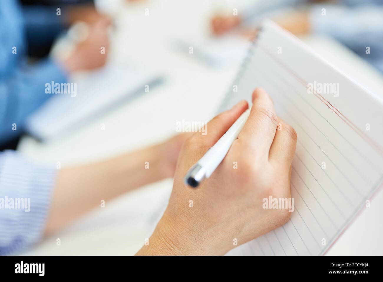 Hand of a businesswoman is making notes in a writing pad Stock Photo ...