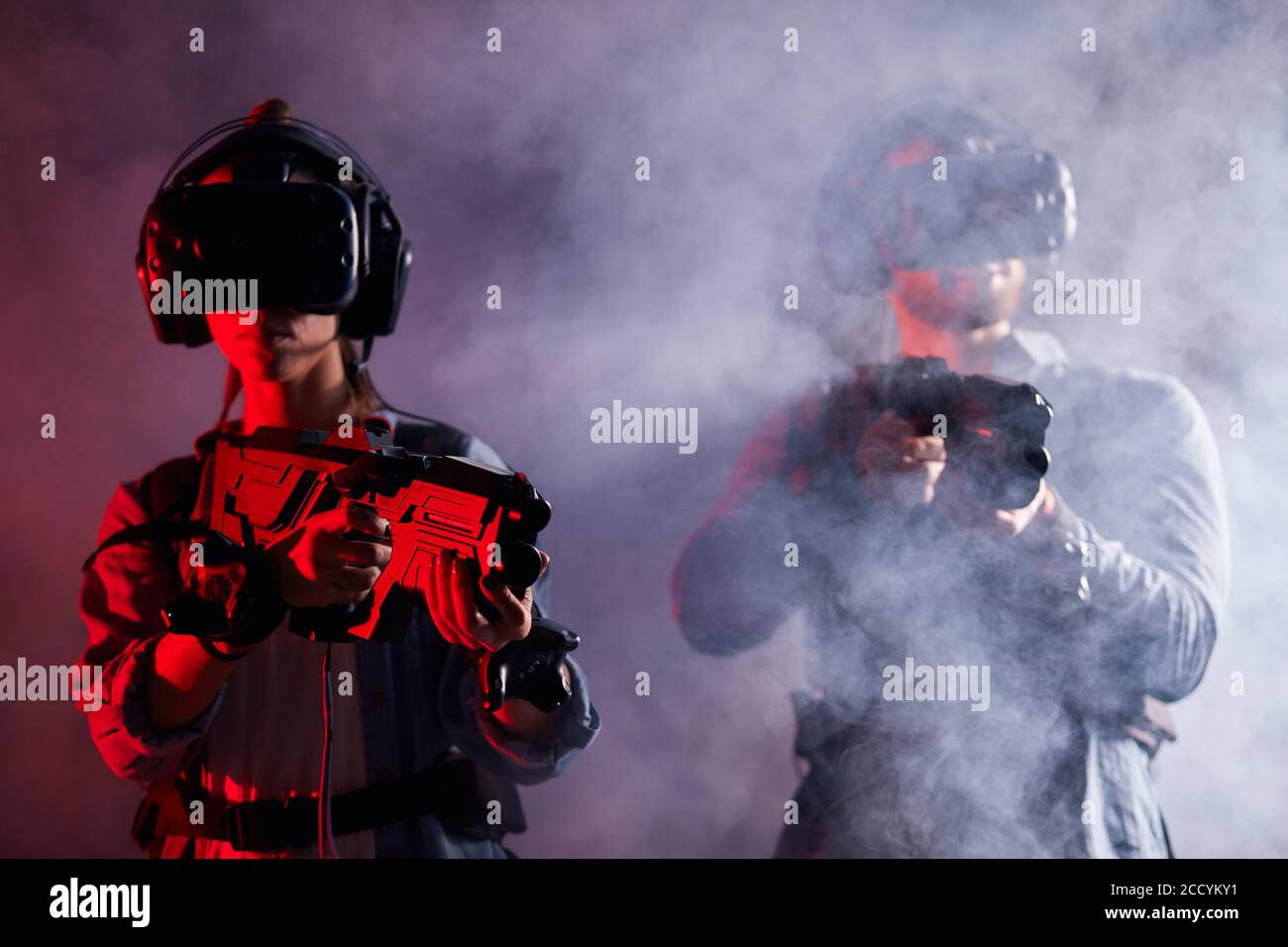 VR gamers with headset, goggles, wearing special equipment with digital ...