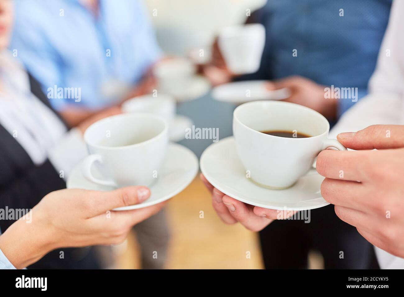 Business people having a break in the office while drinking coffee or ...