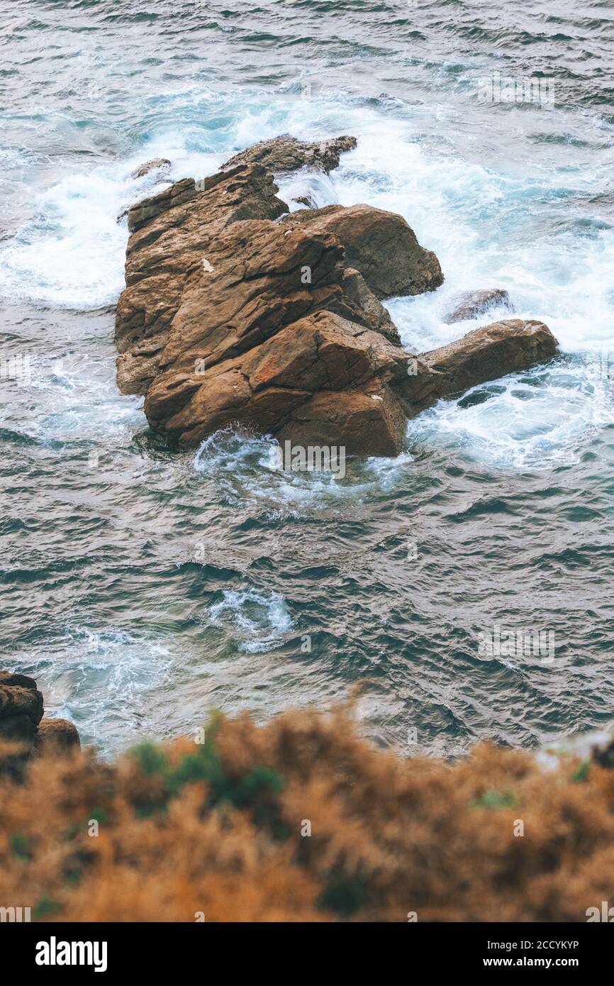 Vertical shot of rocks in the water Stock Photo - Alamy