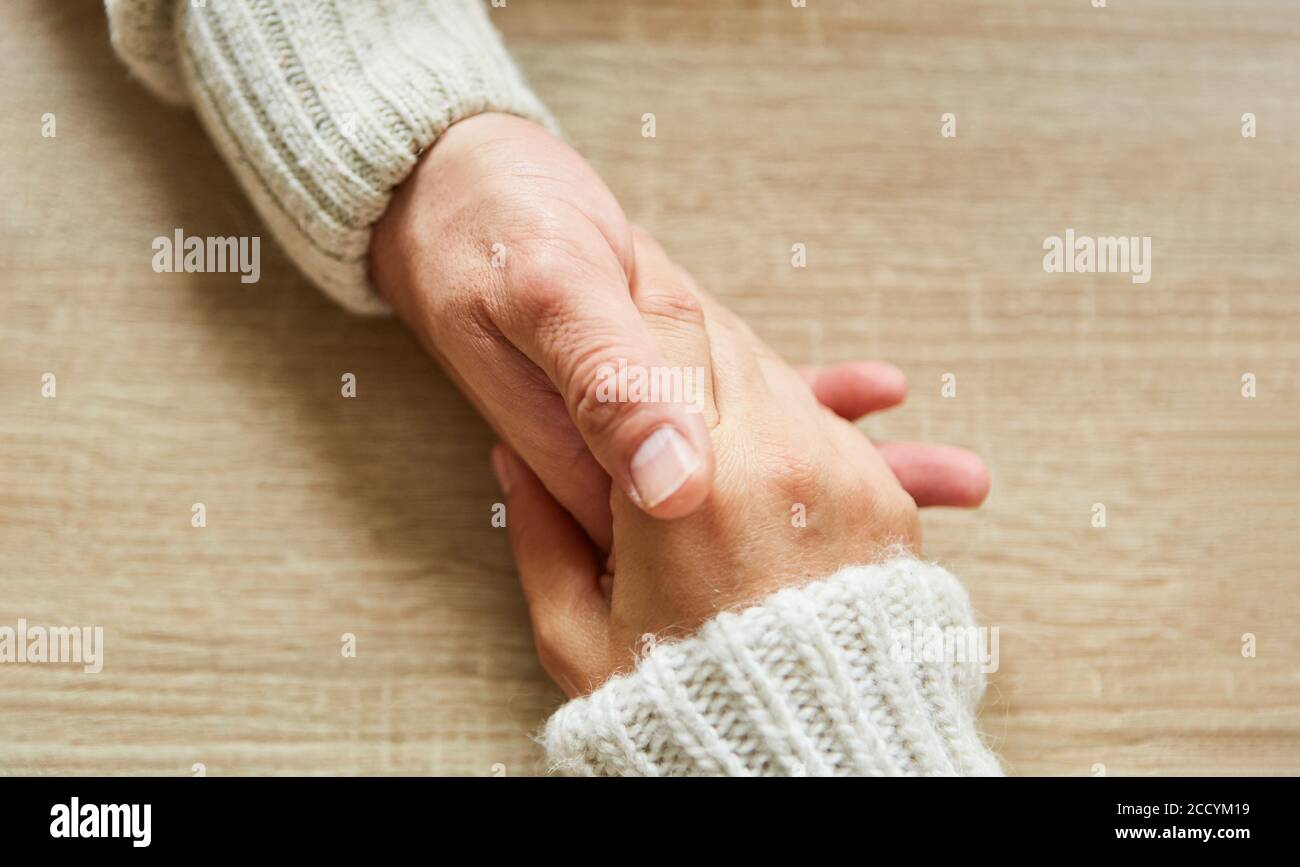 Caring hand holds hand of a senior for comfort and support Stock Photo ...