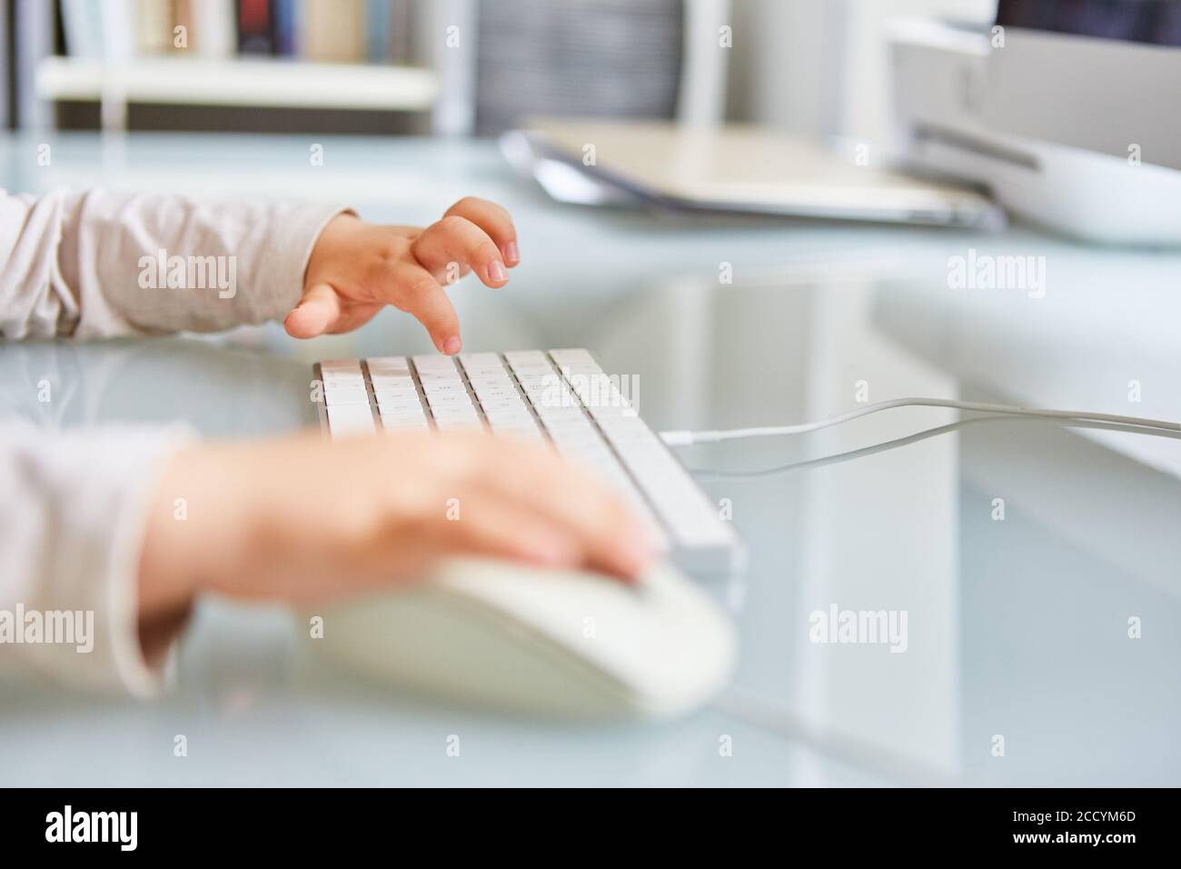 Hands of baby or toddler typing on a computer keyboard Stock Photo - Alamy