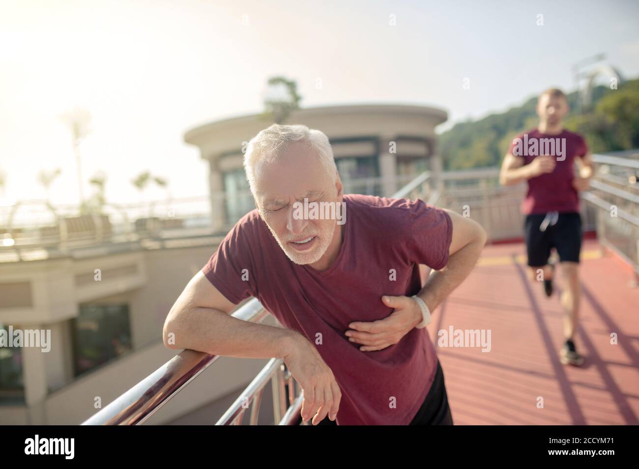 Young man chest pain jogging hi-res stock photography and images - Alamy