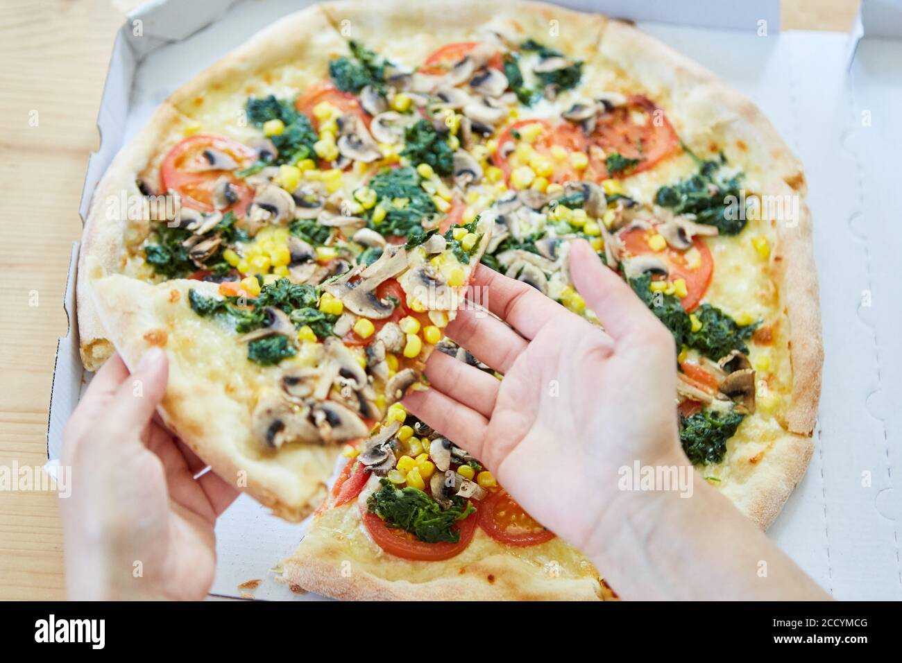 Hands share pizza hi-res stock photography and images - Alamy