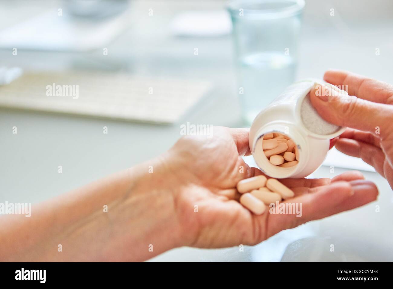 Patient pours tablets from a pack onto his hand in therapy Stock Photo ...