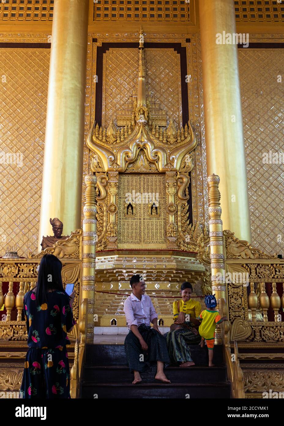 Burmese family taking a picture with smartphone. Young parents. Palace ...