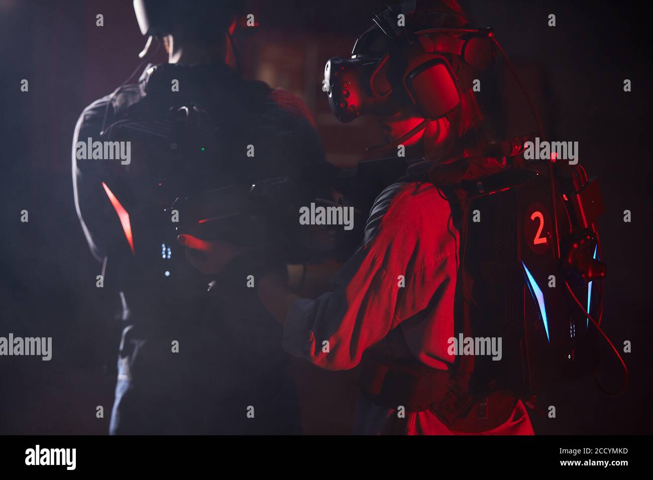 two young male and female fight with someone in virtual reality wearing ...