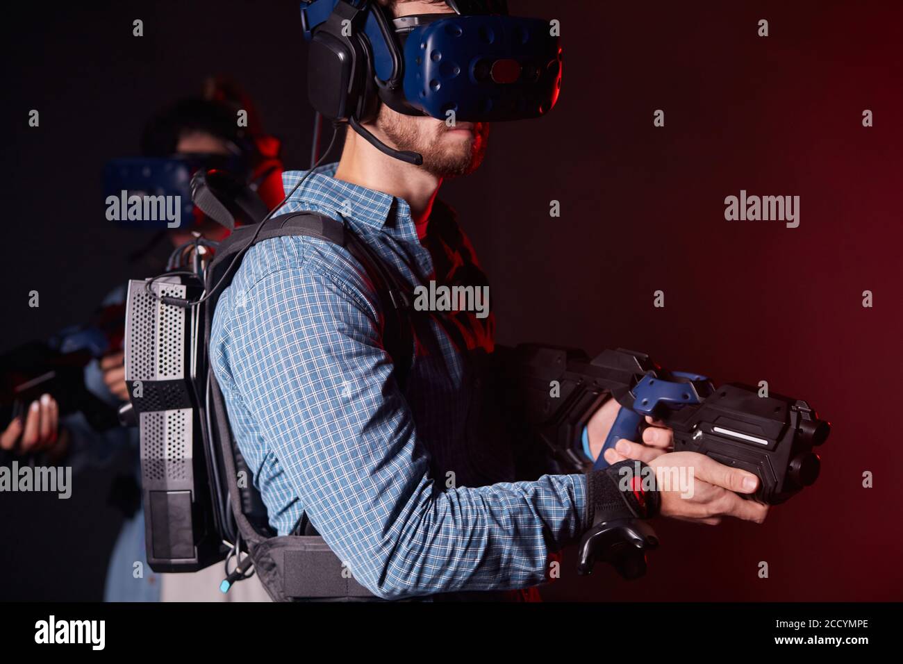 Guy holding VR sniper game with virtual reality gun and headsets ...