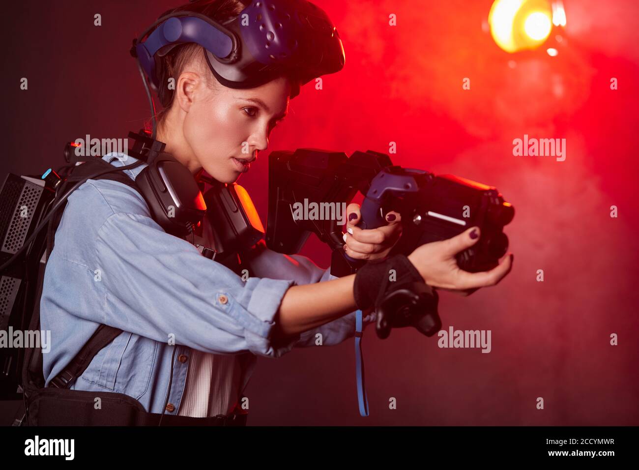 Shooting games, side view on woman in special clothes wearing equipment ...