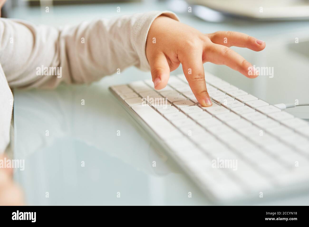 Fingers of baby typing on the computer keyboard on a desk Stock Photo ...