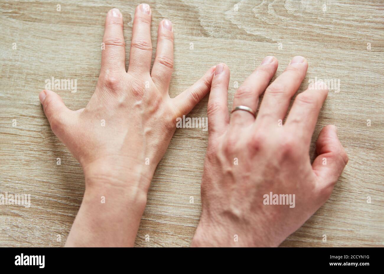 The fingers of a woman and man touch as a sign of love and togetherness ...